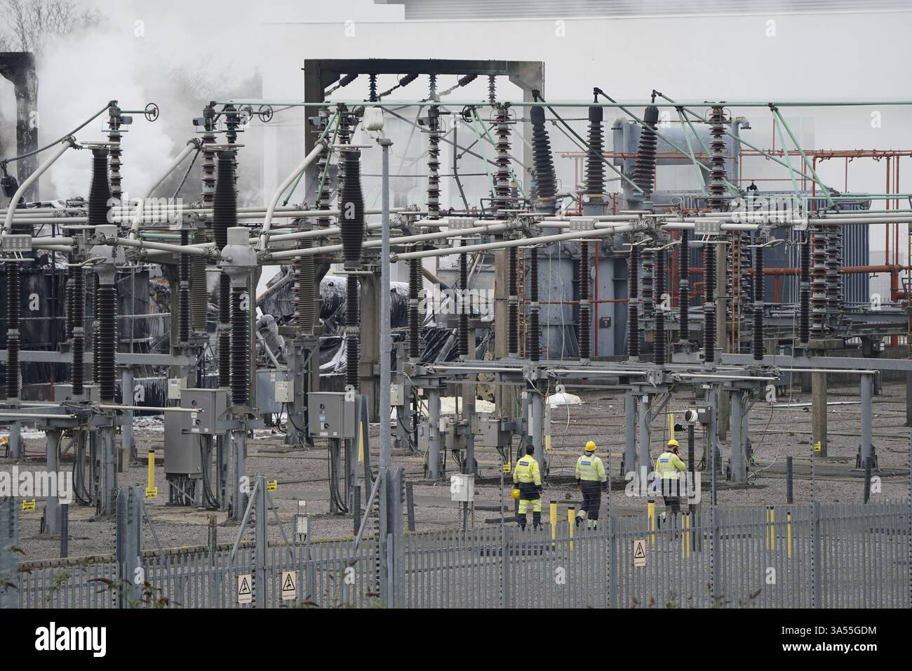 Electricity workers at the North Hyde electrical substation which caught fire. More than 1,300 ...