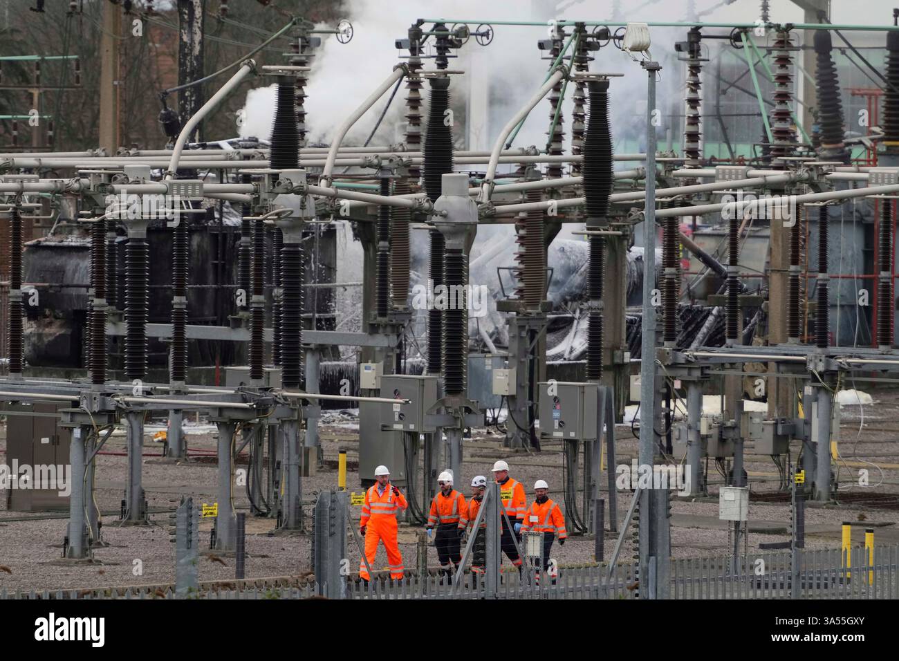 Workers inspect the site of the fire at the North Hyde electrical ...