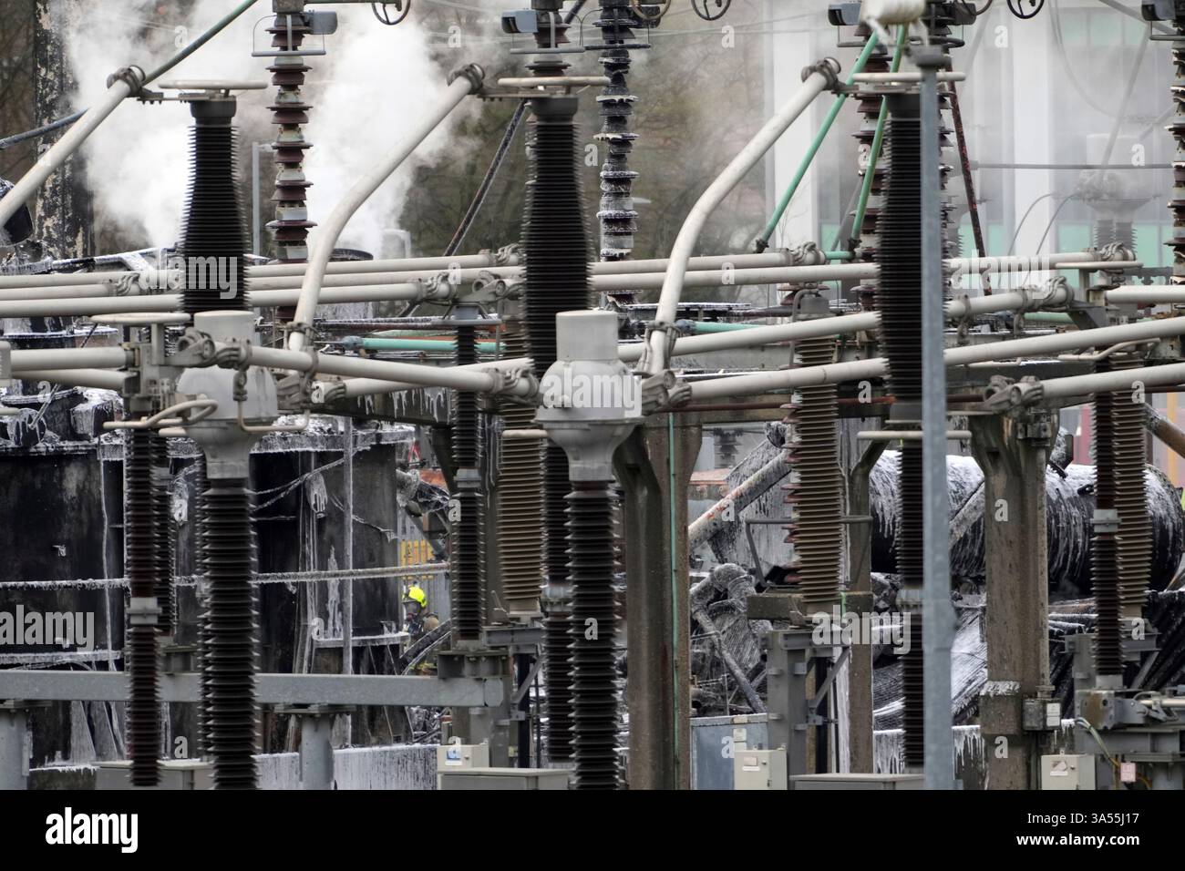 Smoke still rises as firefighters inspect the site of the fire at the ...