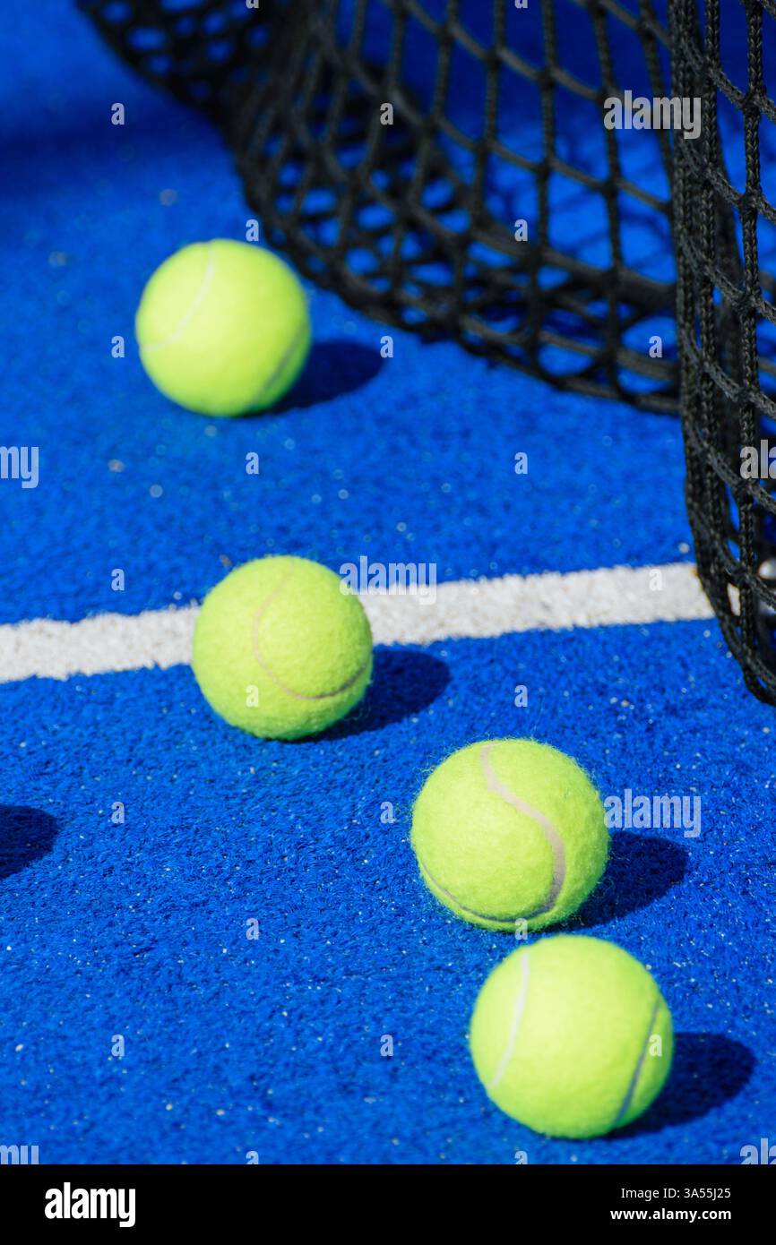 five padel tennis balls near the neat ina blue paddle tennis court ...