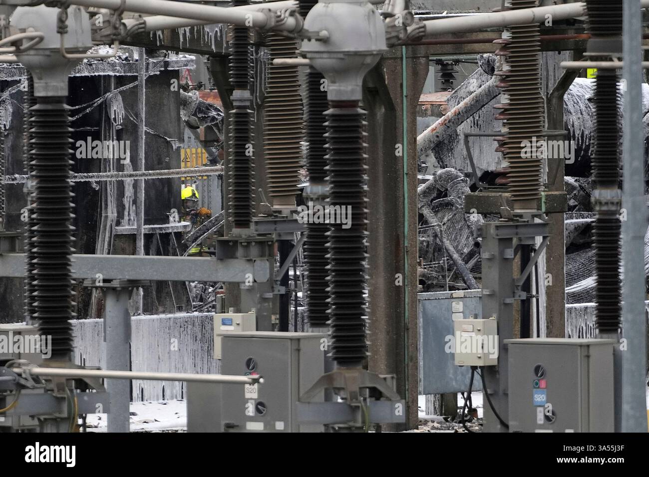Smoke still rises as firefighters inspect the site of the fire at the ...