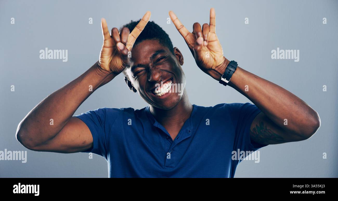 Space, happy or portrait of black man with rock hand gesture in studio ...