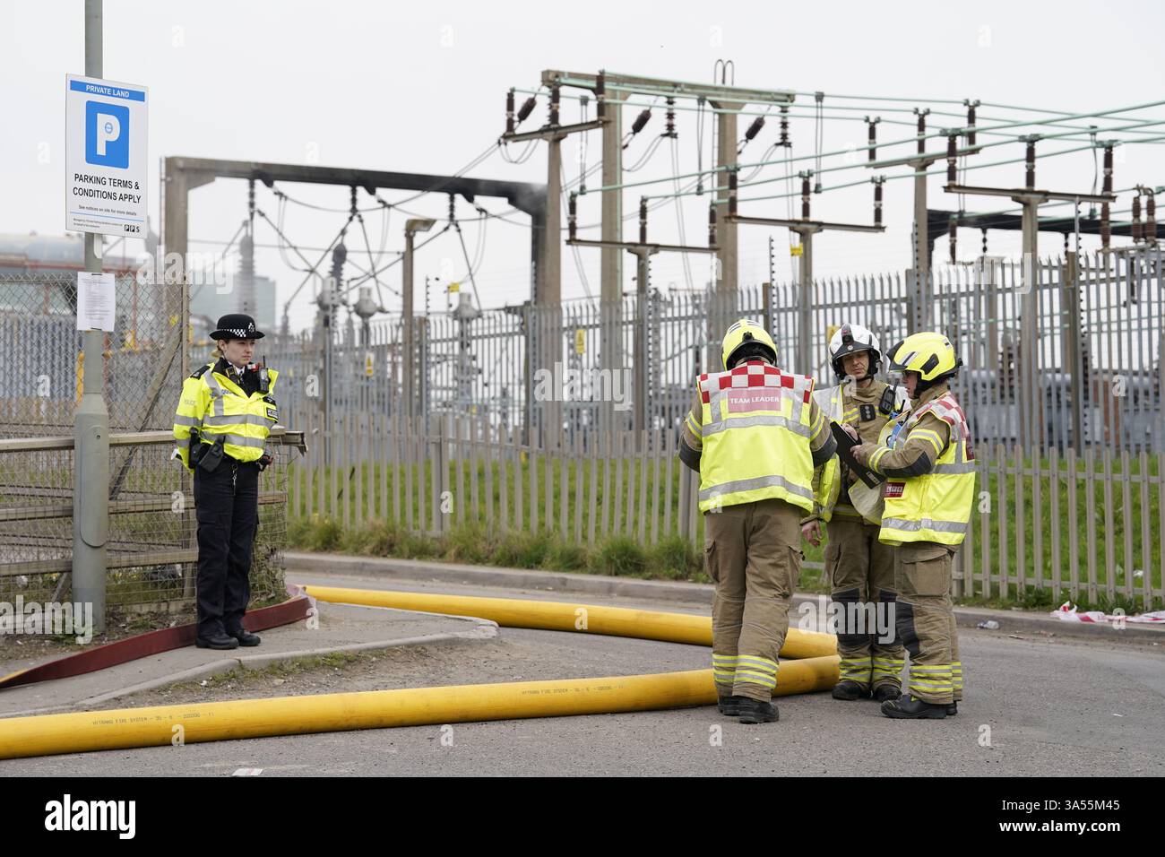 A police officer and firefighters at the North Hyde electrical ...