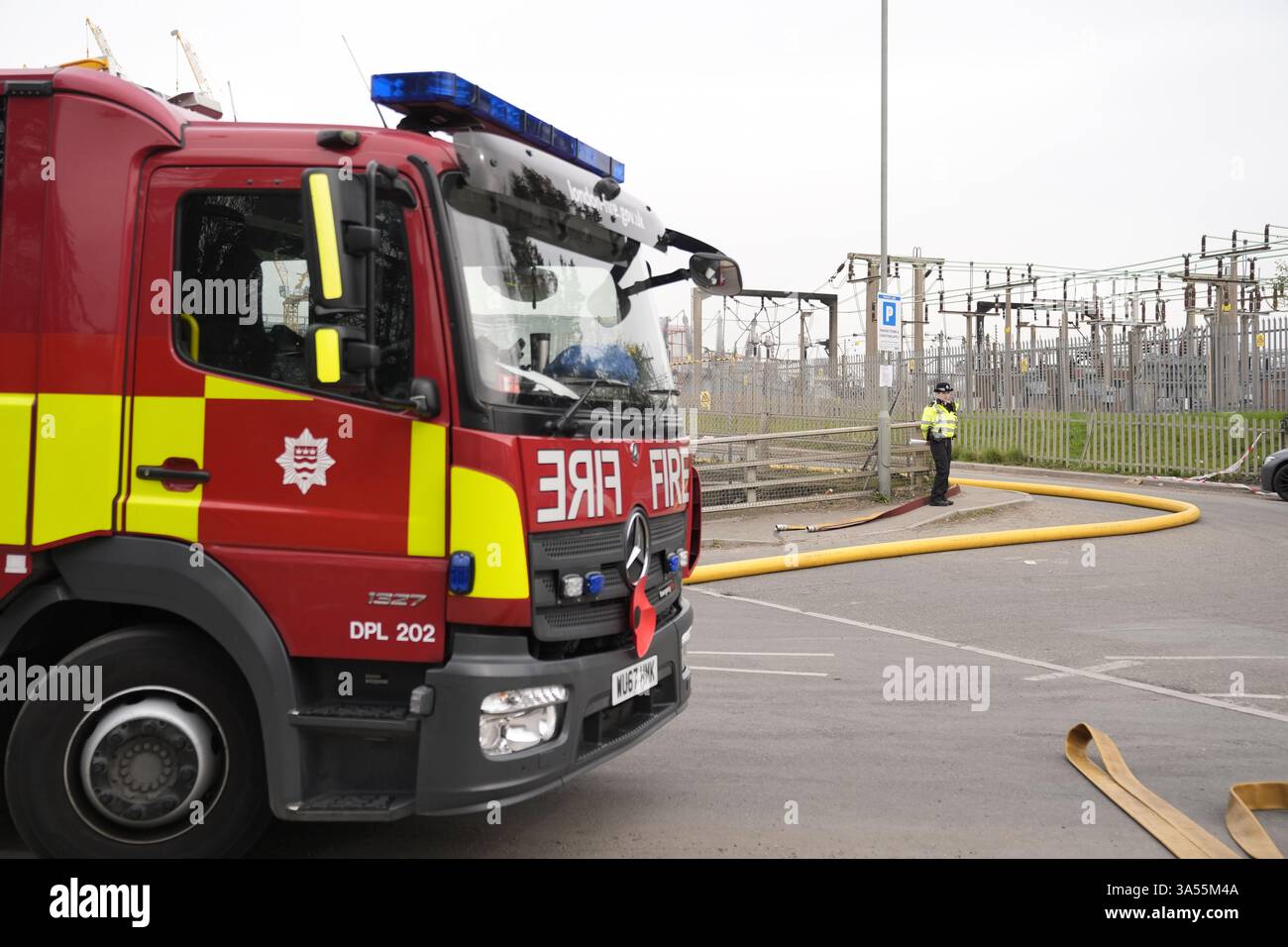 A police officer and firefighters at the North Hyde electrical ...