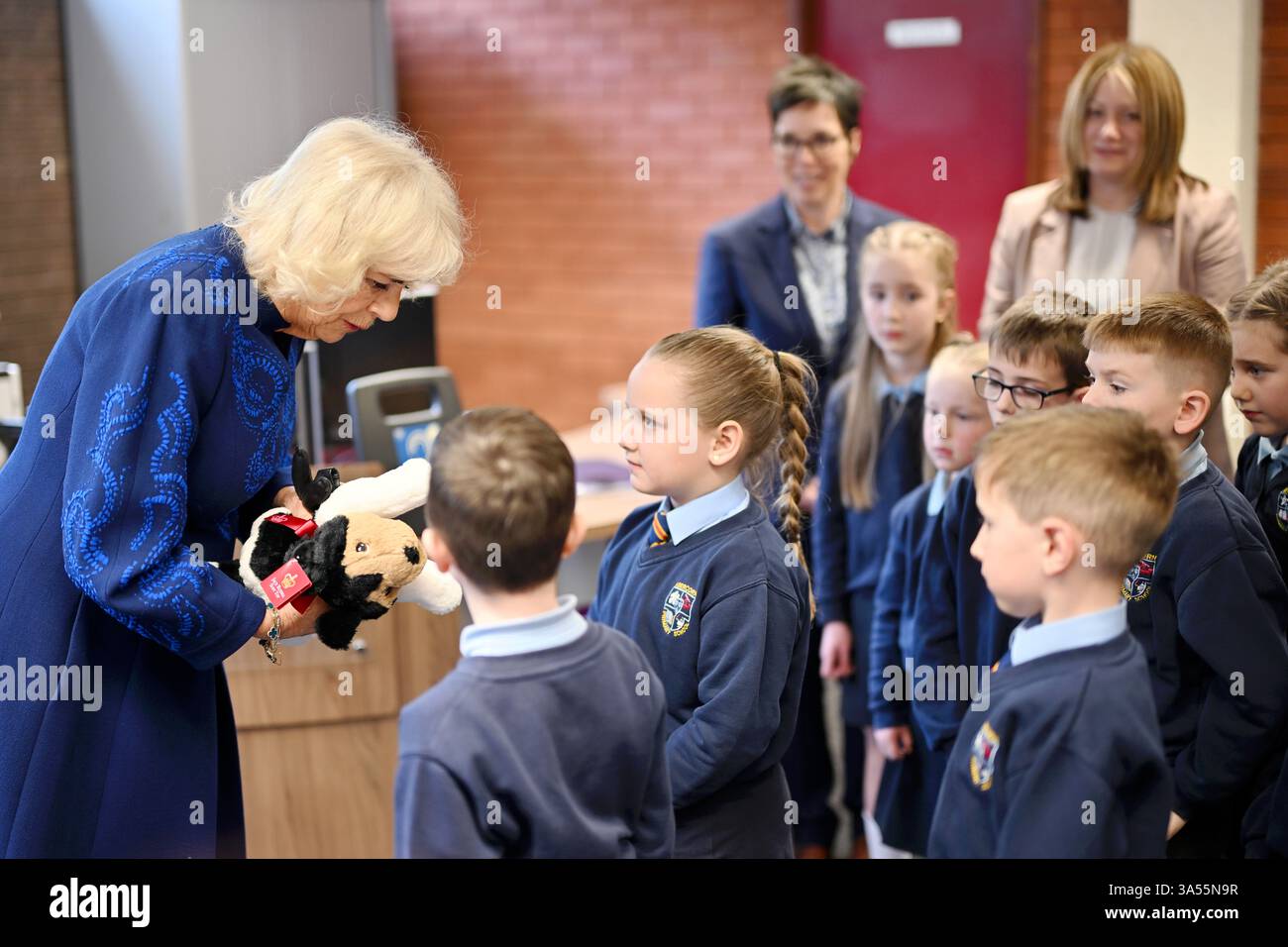 Queen Camilla talks with school children during a visit to Banbridge ...