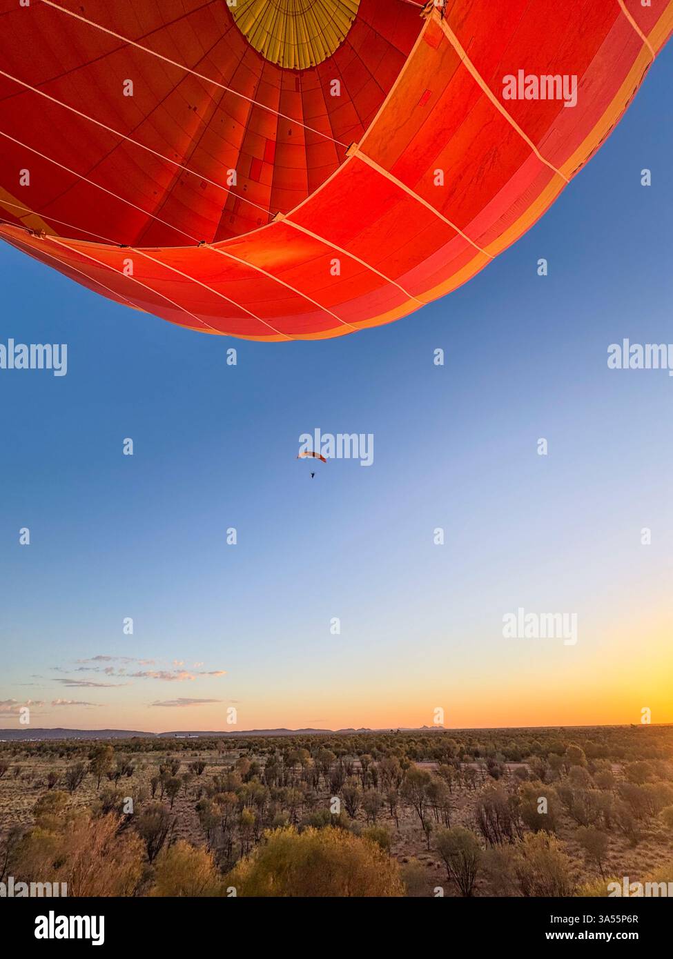 Hot air balloon ride, Paraglider with motor passes the hot air balloon ...