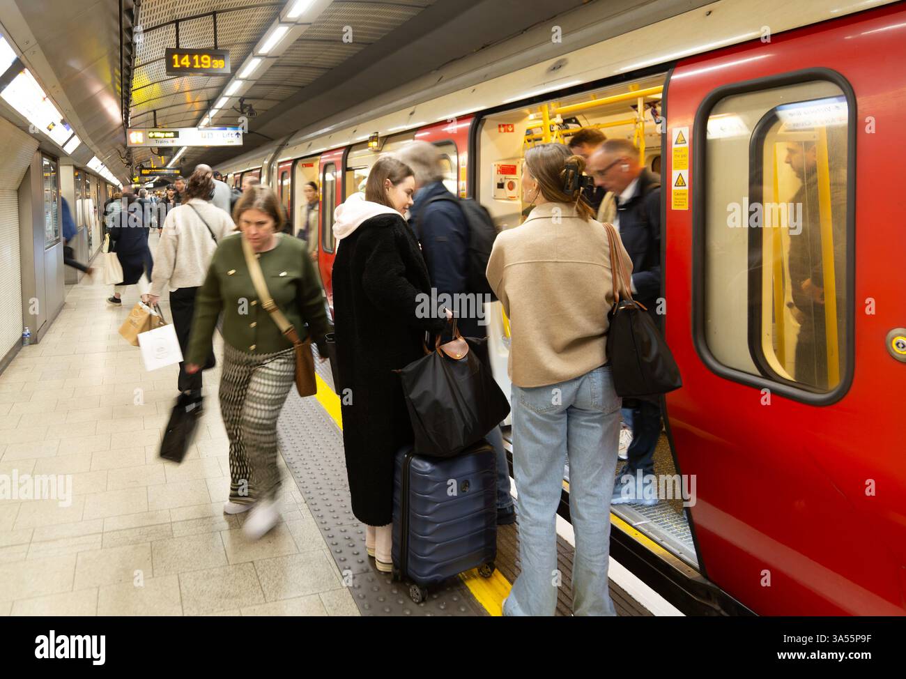 Crowded underground tube train arriving at station platform, Kings ...