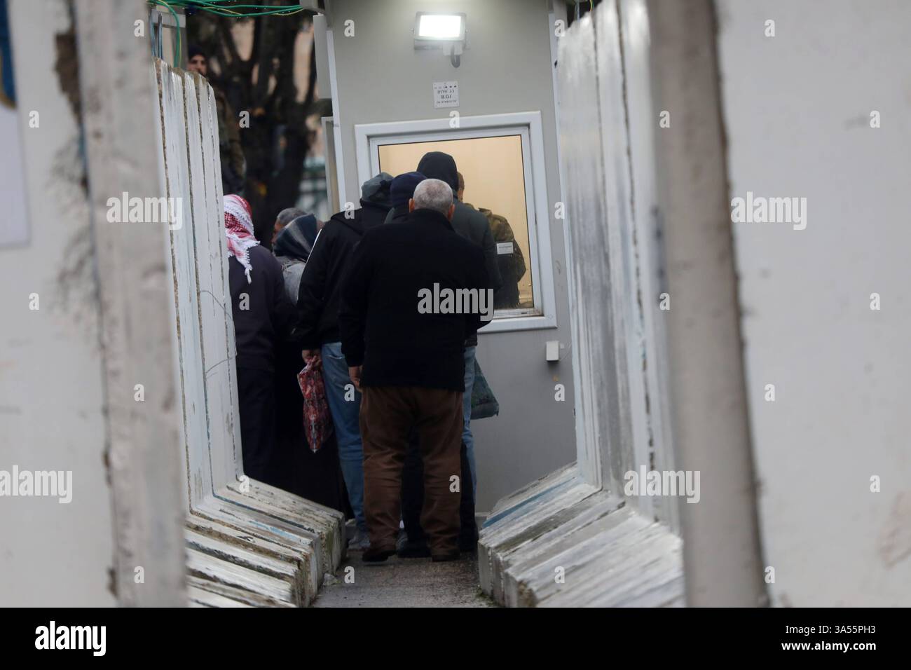 Palestinians, living in West Bank, gather at the Israeli military ...