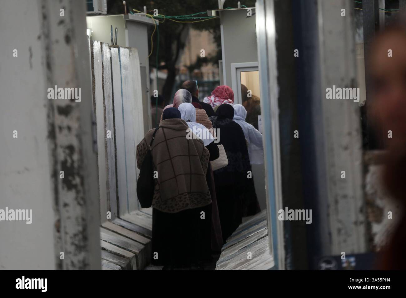 Palestinians, living in West Bank, gather at the Israeli military ...