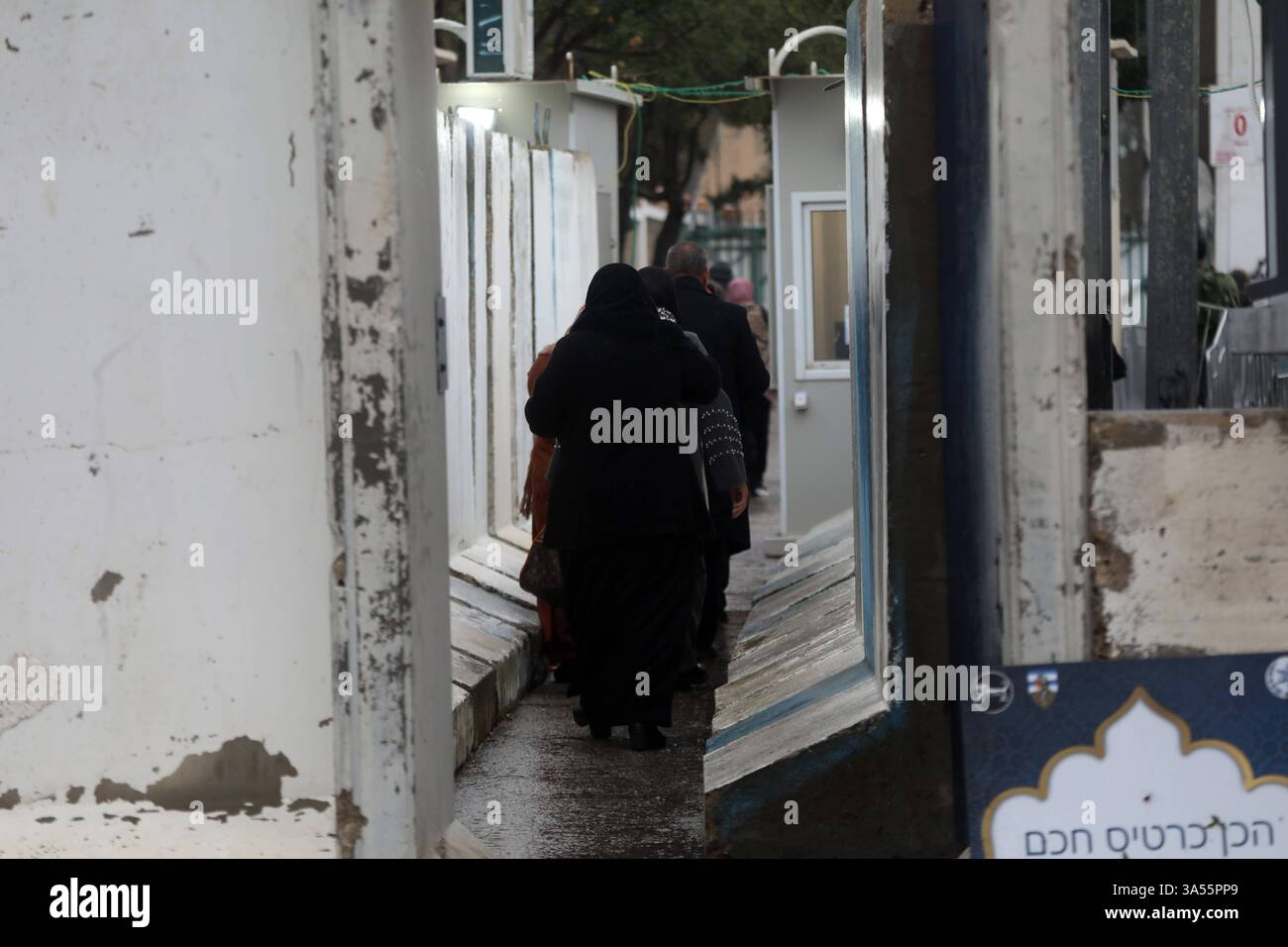 Palestinians, living in West Bank, gather at the Israeli military ...
