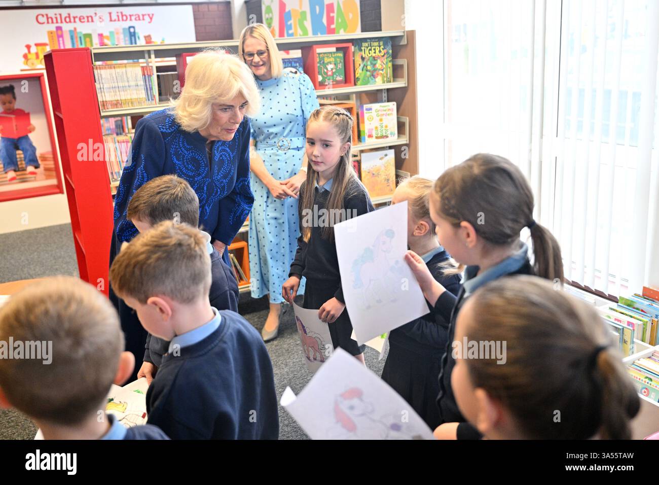 Queen Camilla talks with school children during a visit to Banbridge ...