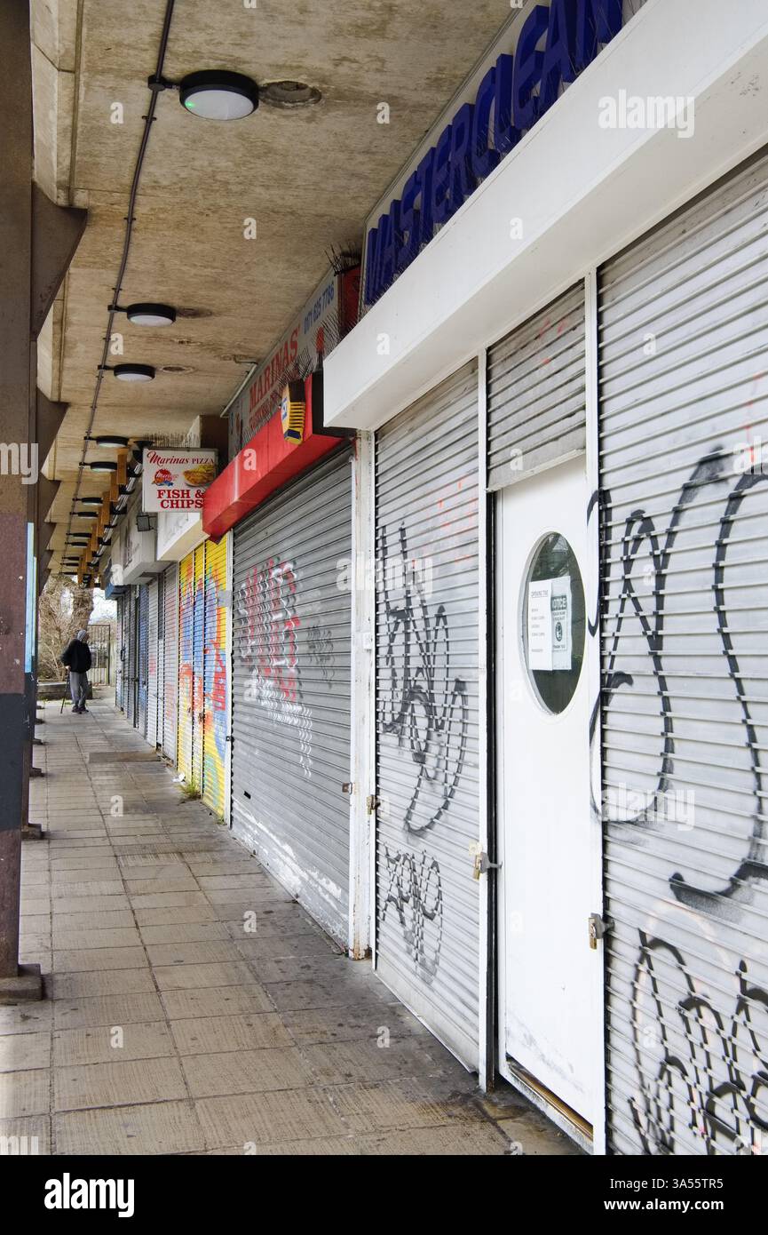 Parade of shuttered shops with graffiti on Alexandra Place in St Johns ...