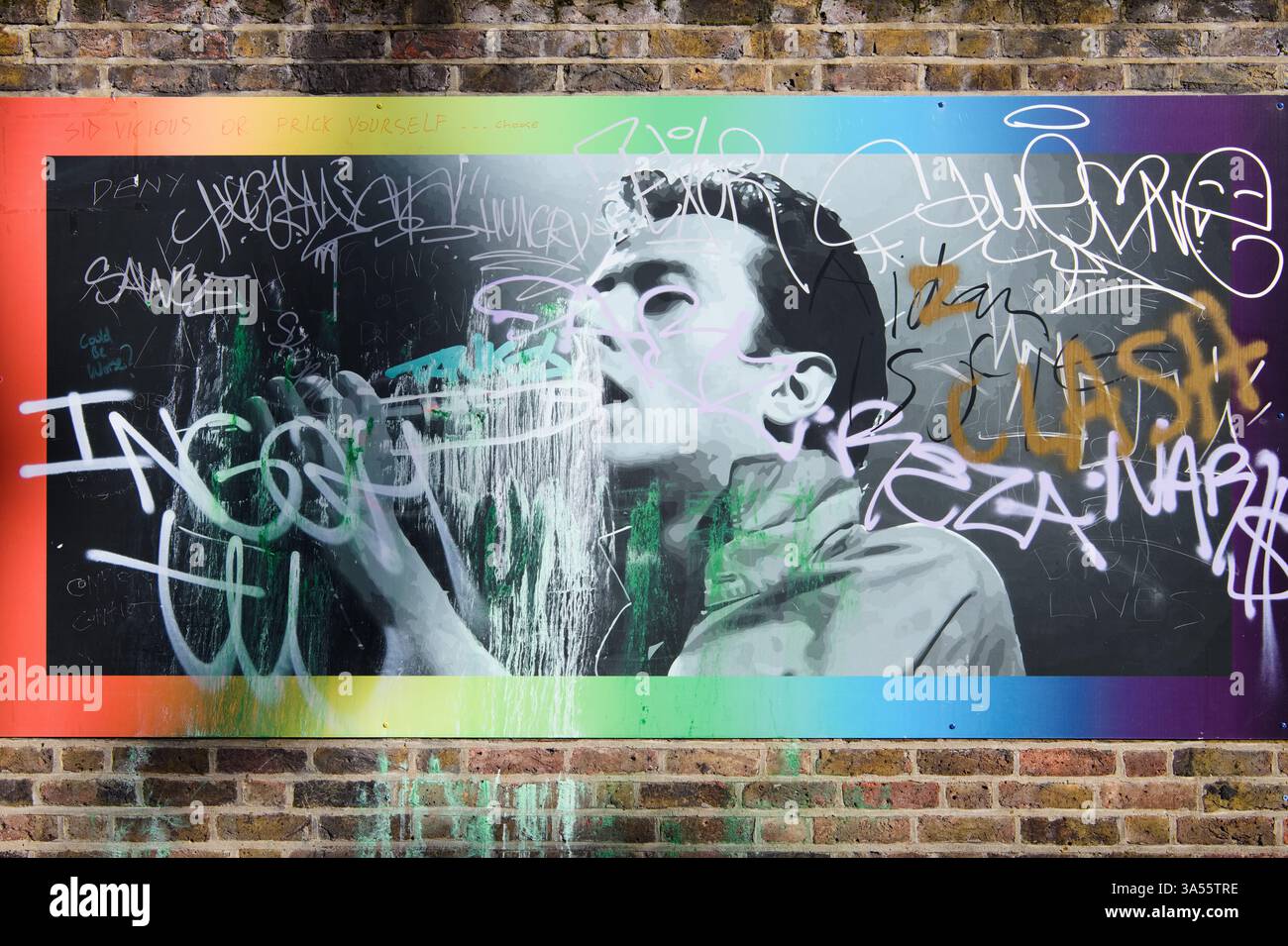 Photographic mural of Joe Strummer of the Clash covered in graffiti on ...