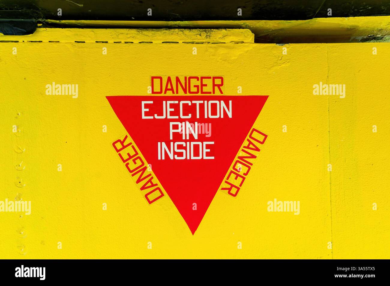 Red triangular warning sign displaying the words danger ejection pin ...