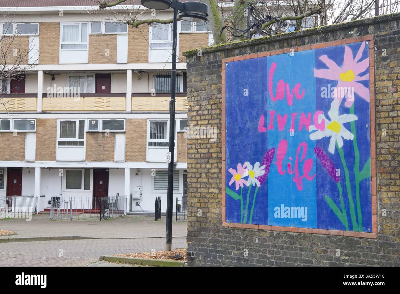 Mural with words "Love living life" on wall in front of flats on Knapp ...