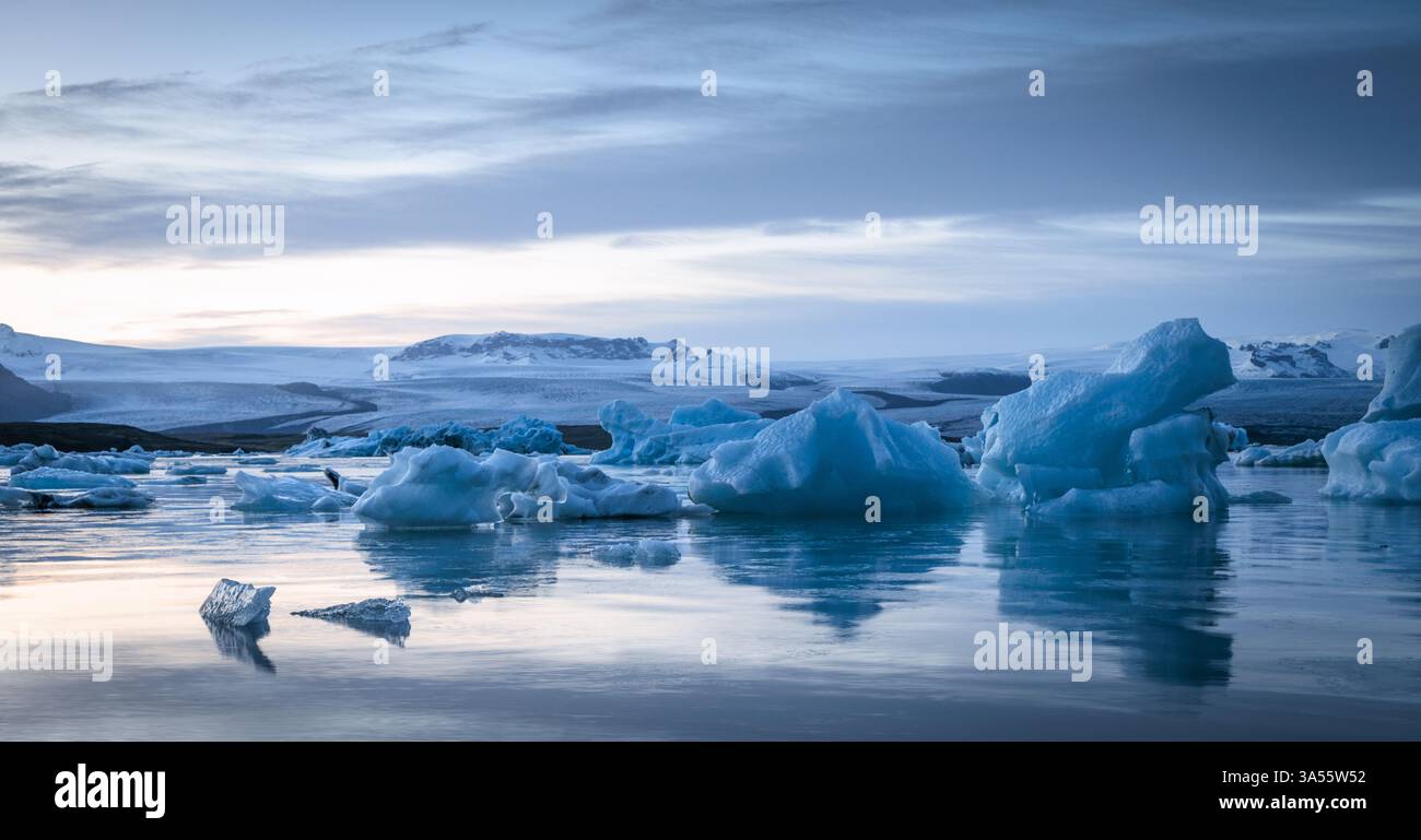 Iceberg in a glacier lagoon in Iceland at sunset with beautiful colors ...