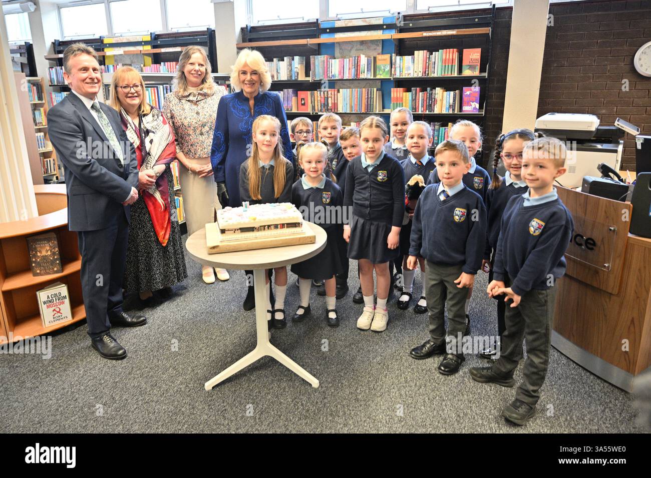 Queen Camilla with school children before cutting a cake during a visit ...