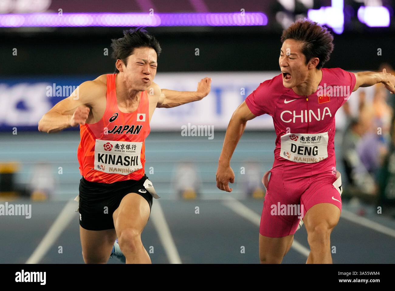Yoshiki Kinashi, of Japan, and Xinrui Deng, of China, compete in a men's 60 meters semifinal at ...