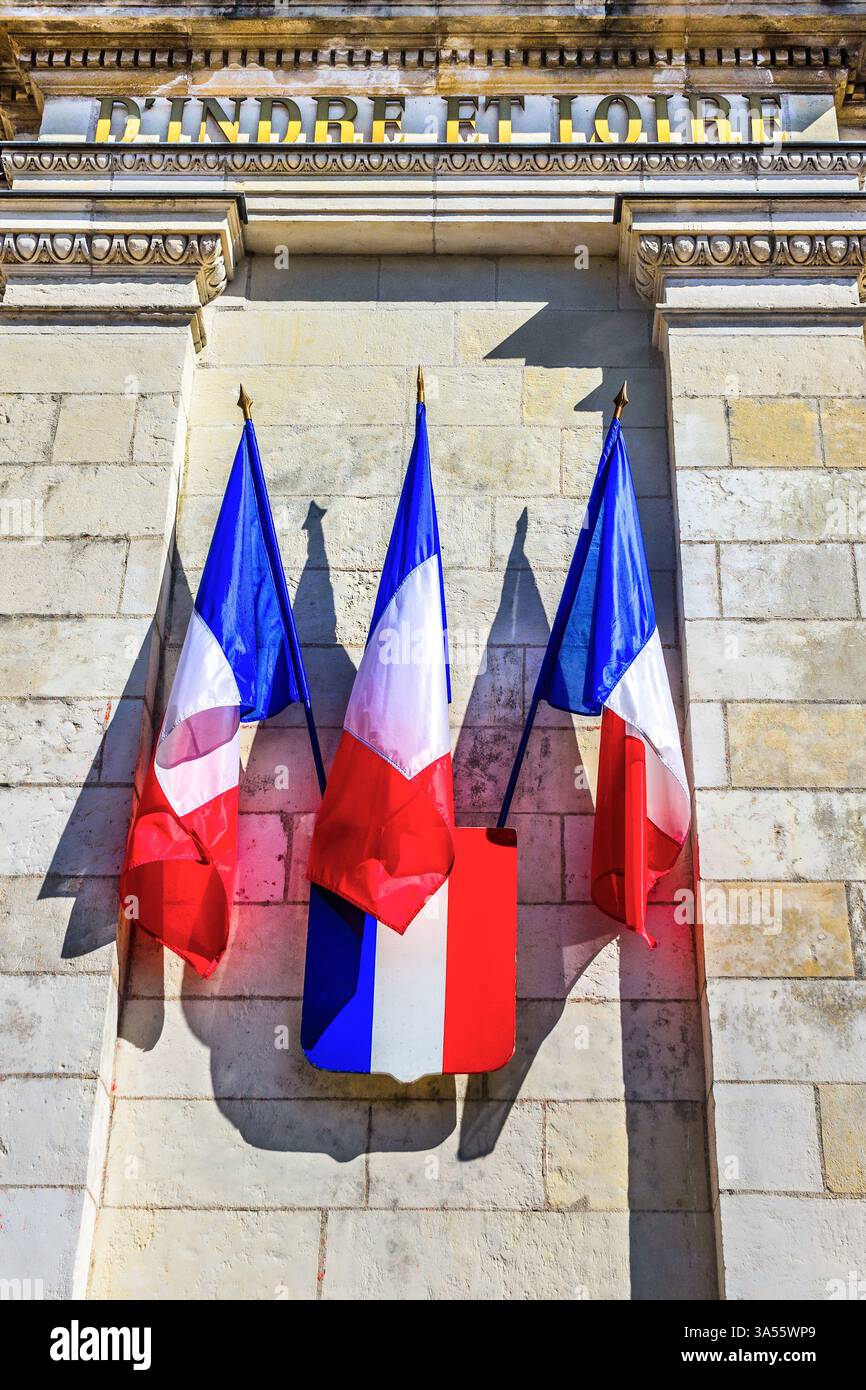 Three French flags and shield outside the entrance to the Prefecture ...