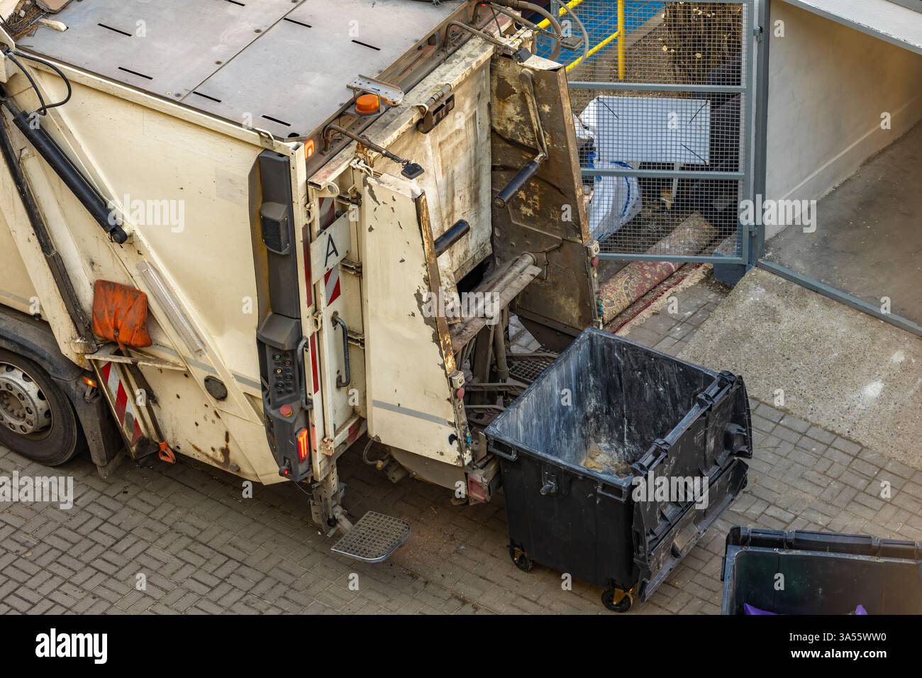 City cleaning services, garbage truck, emptying garbage containers in ...