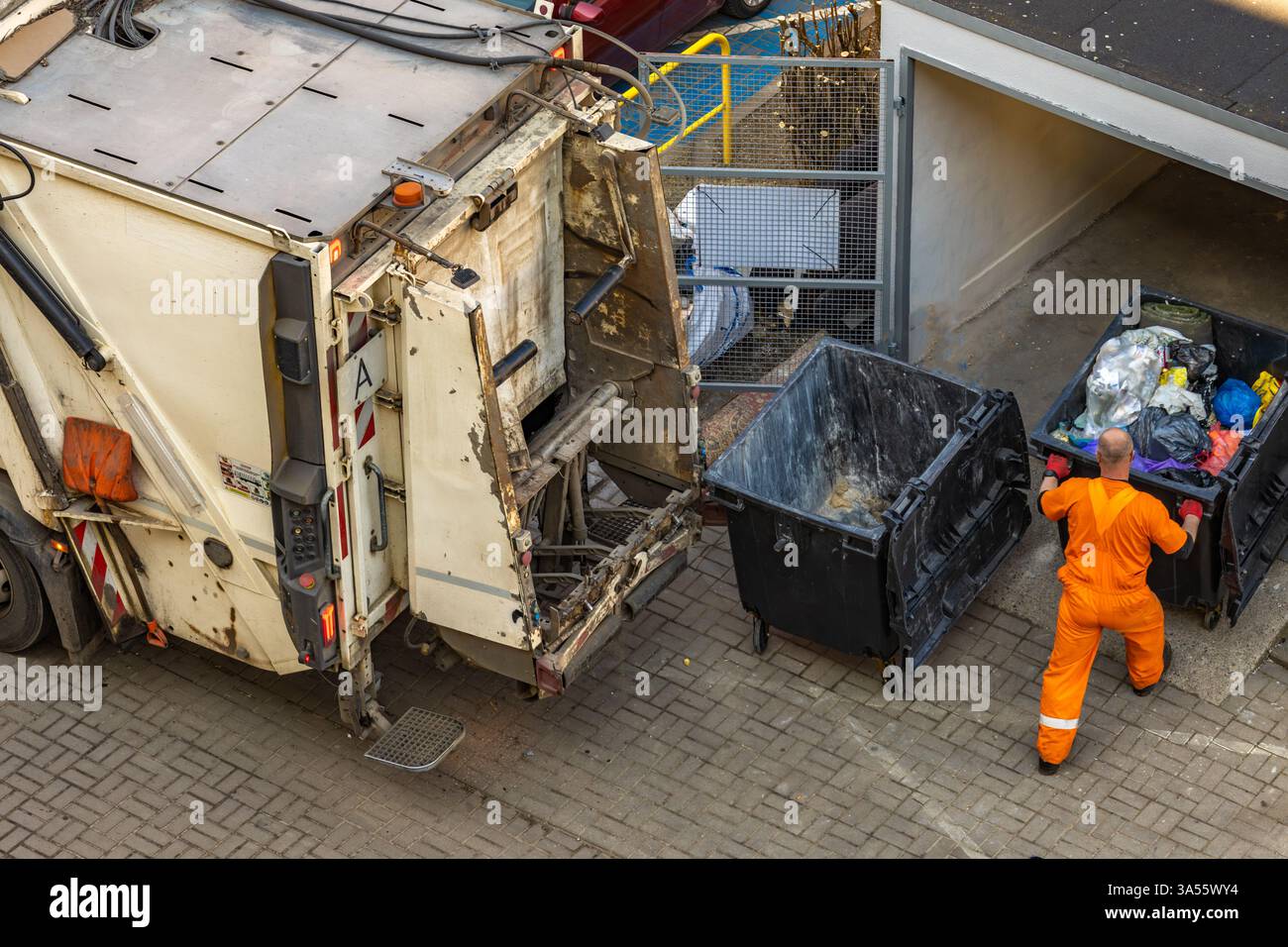 City cleaning services, garbage truck, emptying garbage containers in the city center Stock ...