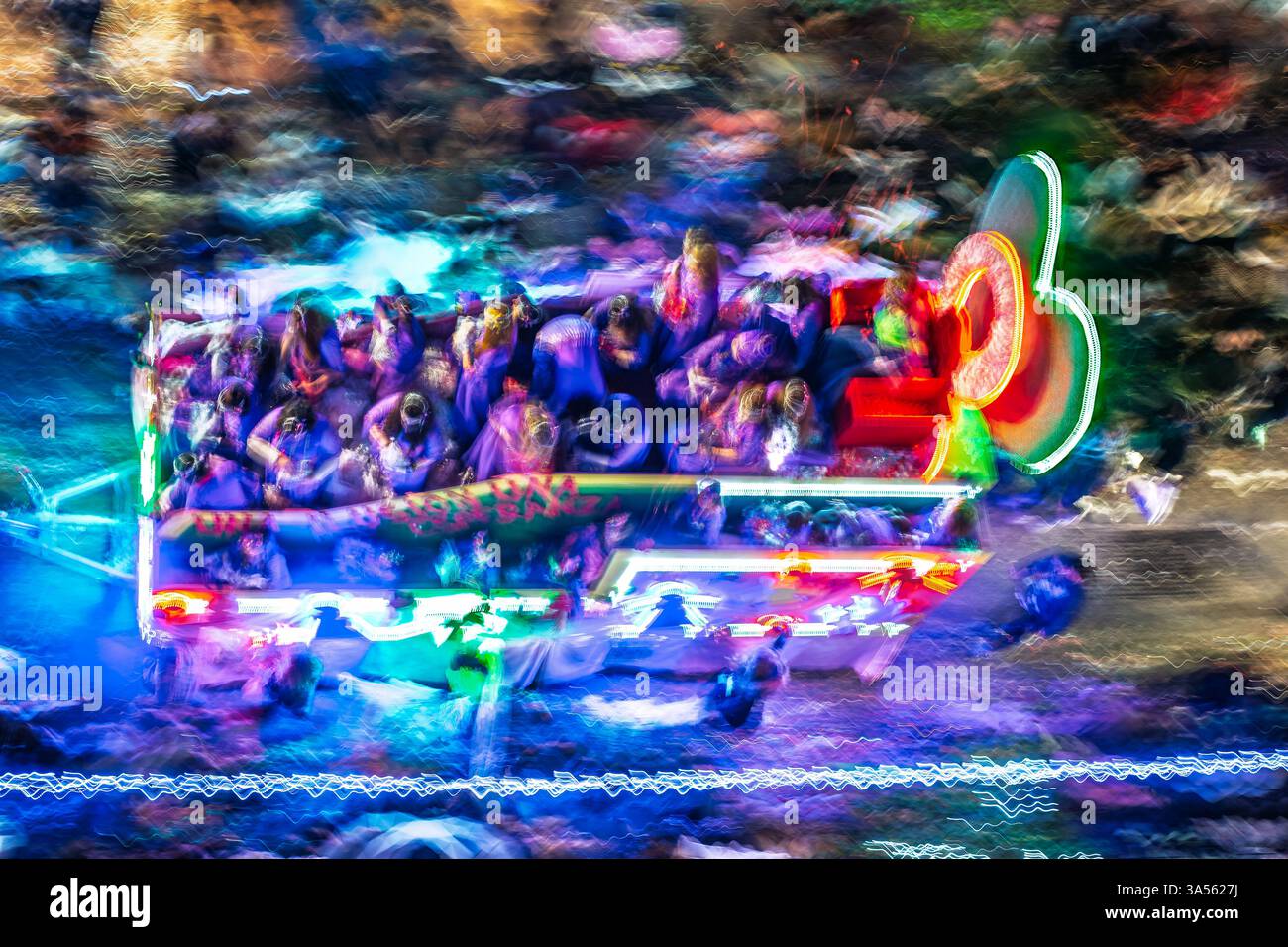 Aerial view of a lively float during a colorful night parade in Seville ...