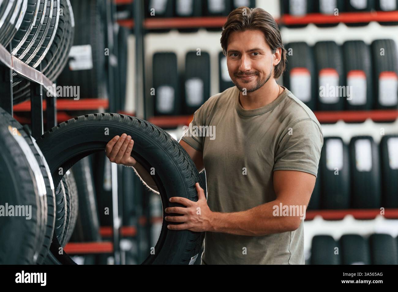 Customer is choosing the tire. Man is in the tire fitting car service ...