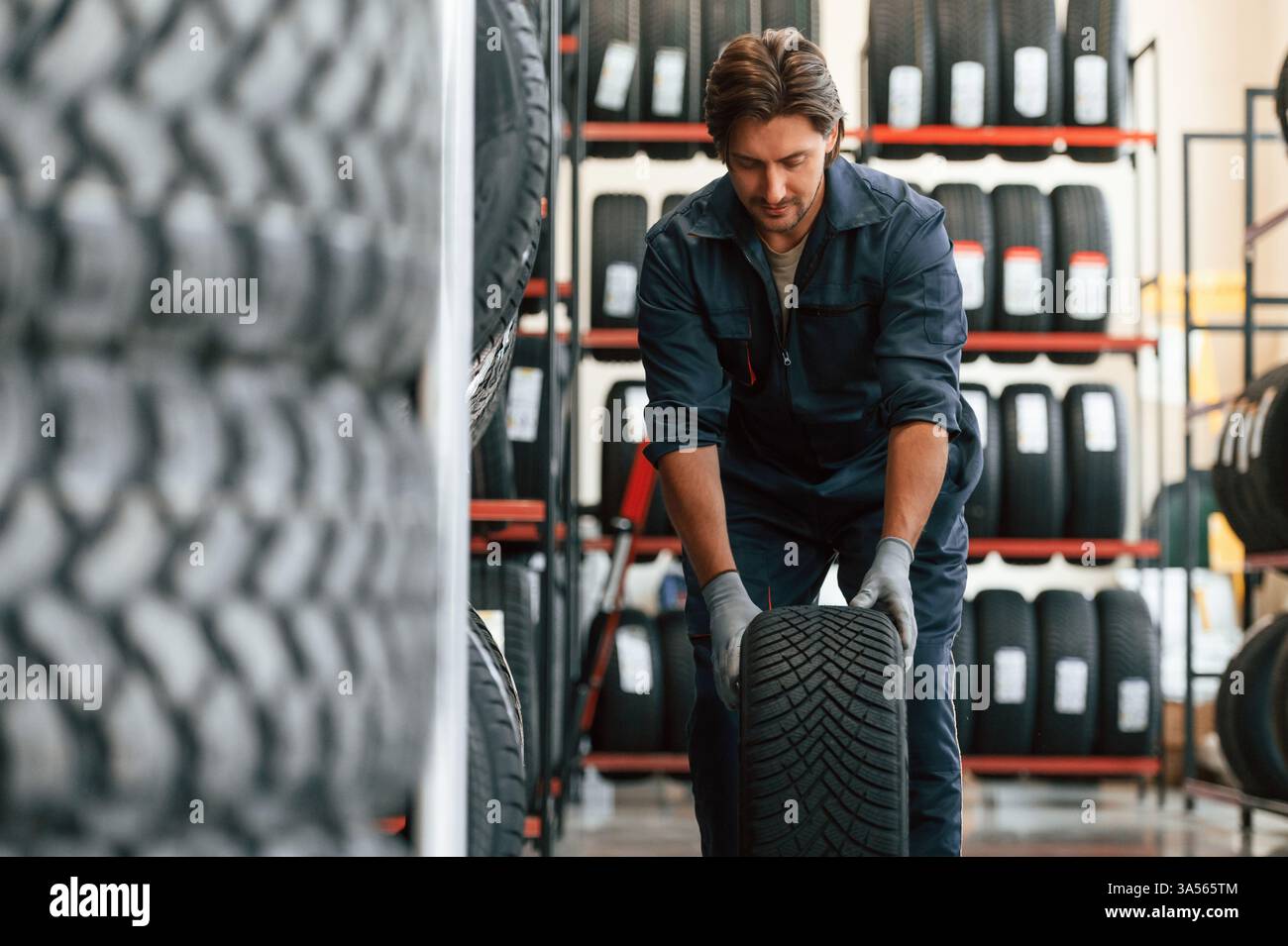 Ready to change the tire. Man is in the tire fitting car service Stock ...