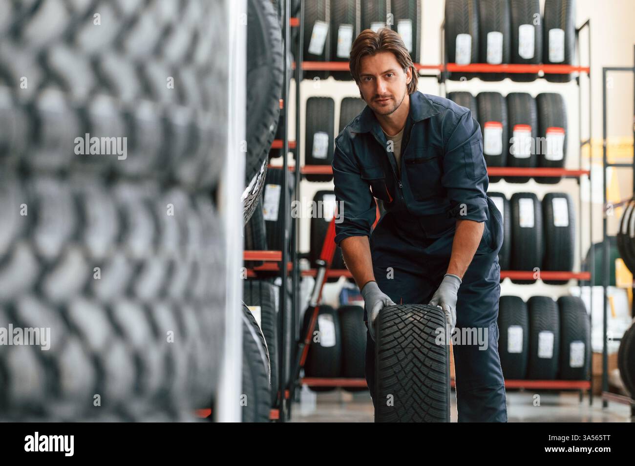 Ready to change the tire. Man is in the tire fitting car service Stock Photo - Alamy