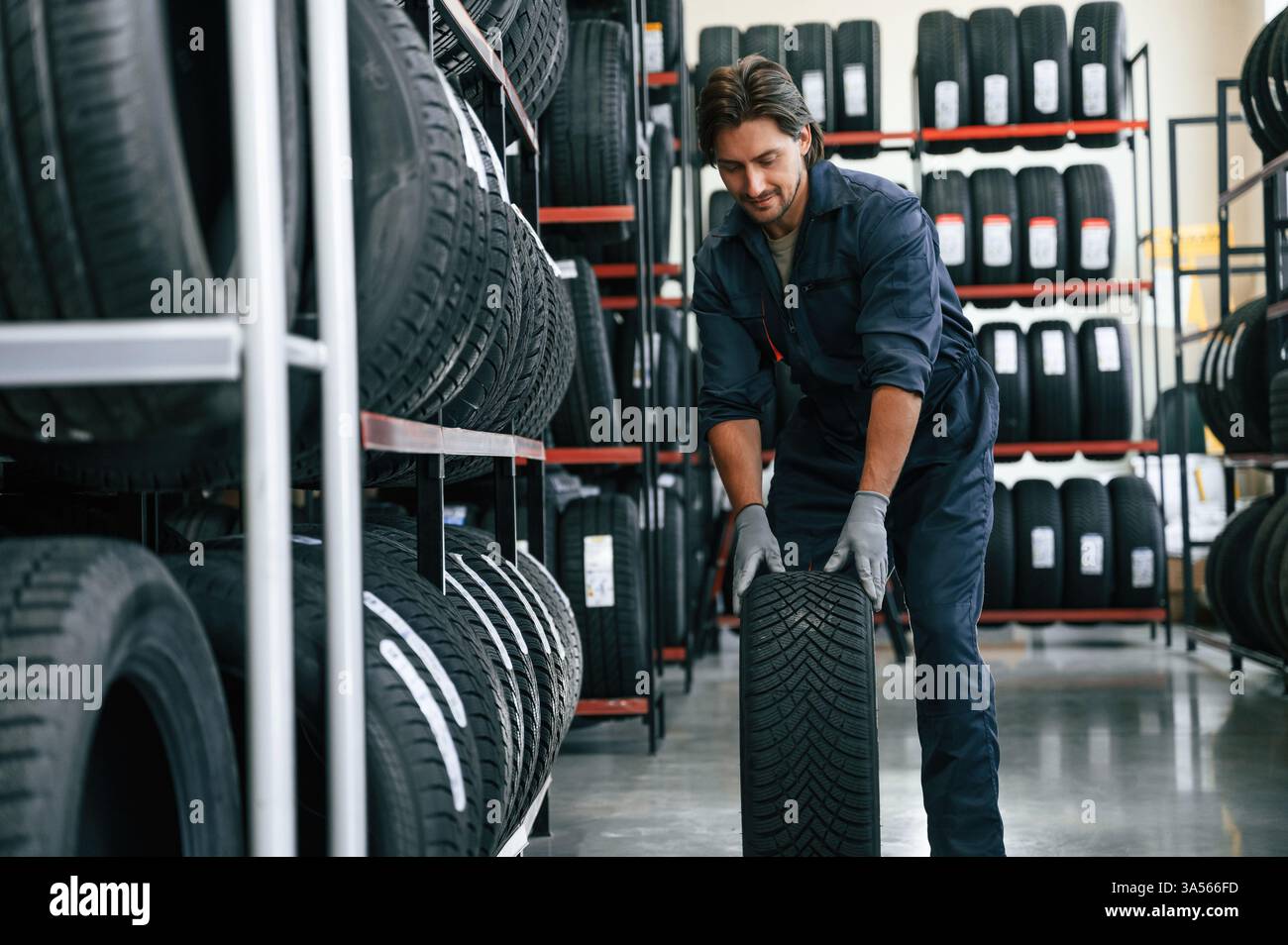 Ready to change the tire. Man is in the tire fitting car service Stock ...
