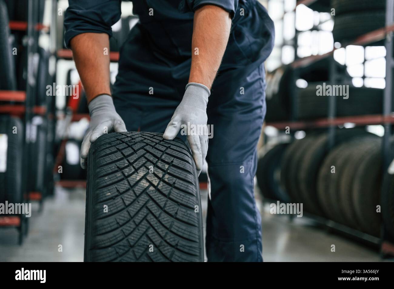 Ready to change the tire. Man is in the tire fitting car service Stock ...