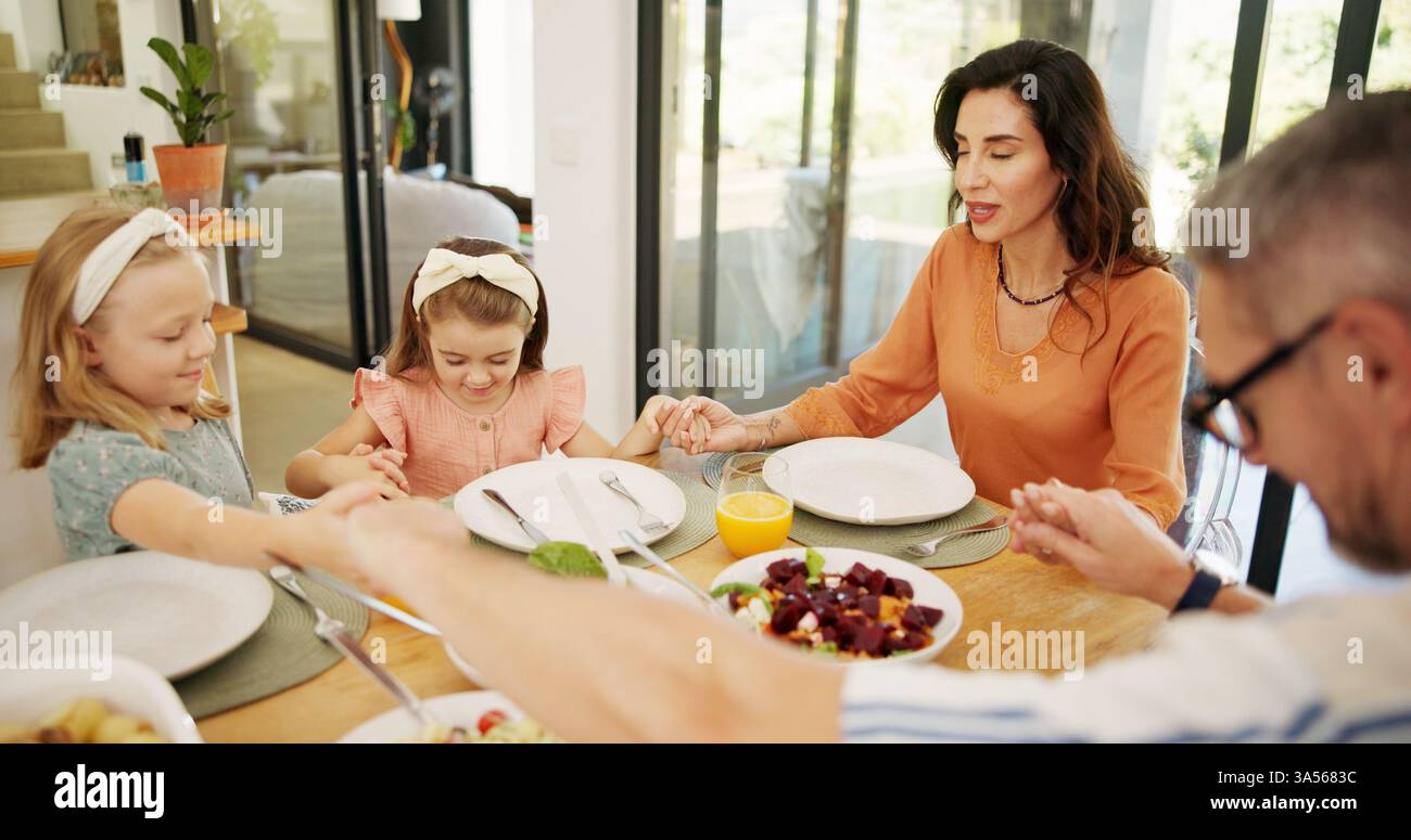 Praying, lunch and family at dining table in house for healthy ...