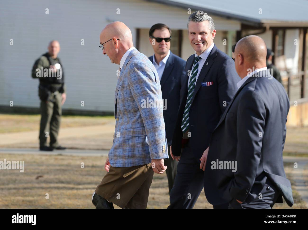 Secretary of Defense Pete Hegseth, center, walks with Scott Burns, left ...