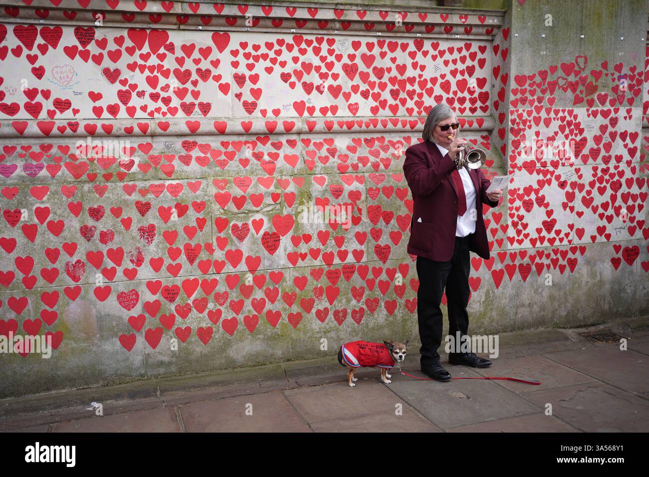 Janet Elaine Berry, with her dog Lizzie, playing a trumpet at the Covid ...