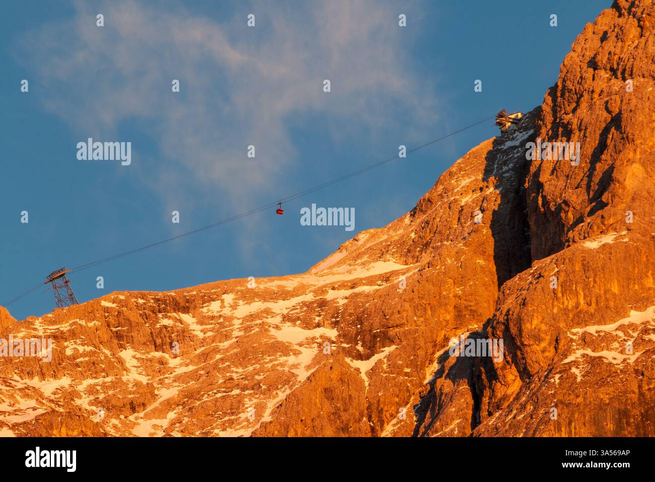 the red cabin of the Rosetta cable car on the Dolomite peaks of San ...