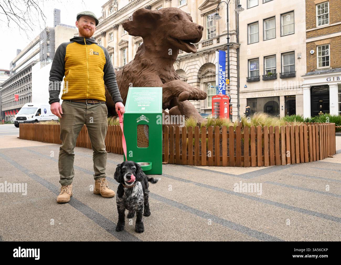 EDITORIAL USE ONLY Sculptor, Jamie Wardley and Ellie the spaniel at the ...