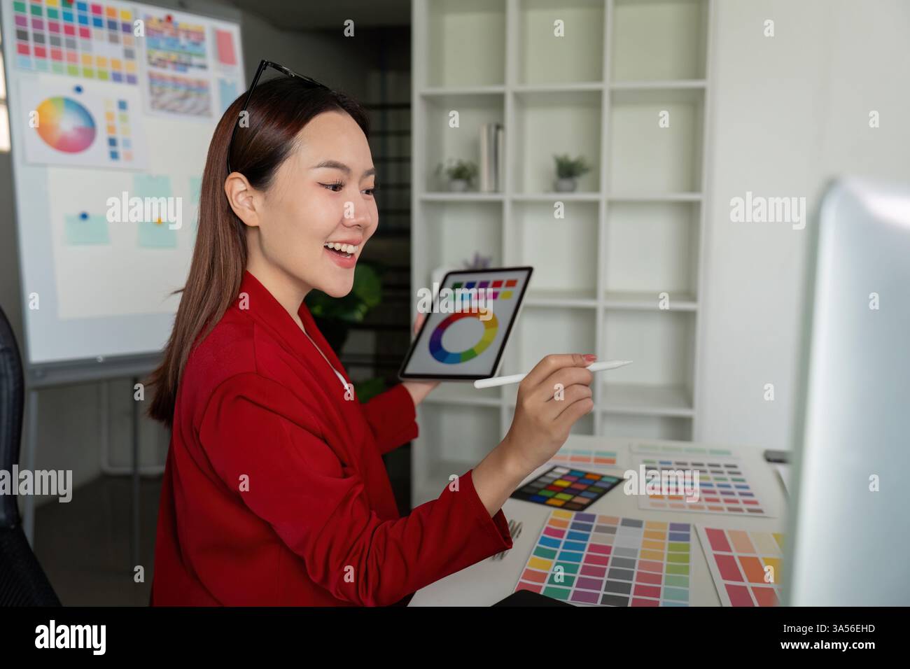 Color Exploration and Digital Design. A designer engaged with a tablet ...