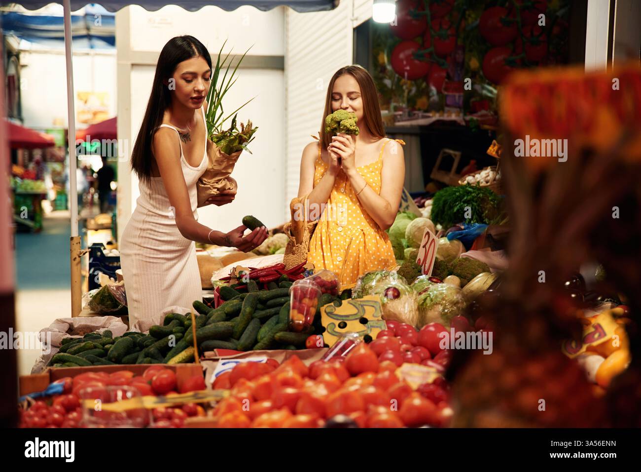Two women are together on the marker or bazaar Stock Photo - Alamy