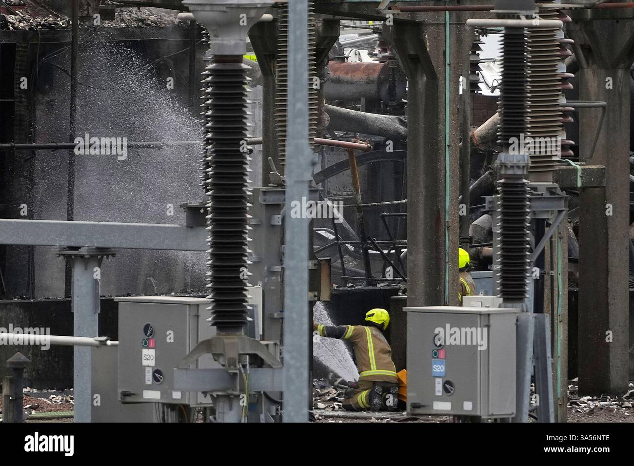 A firefighter works at the North Hyde electrical substation, which ...