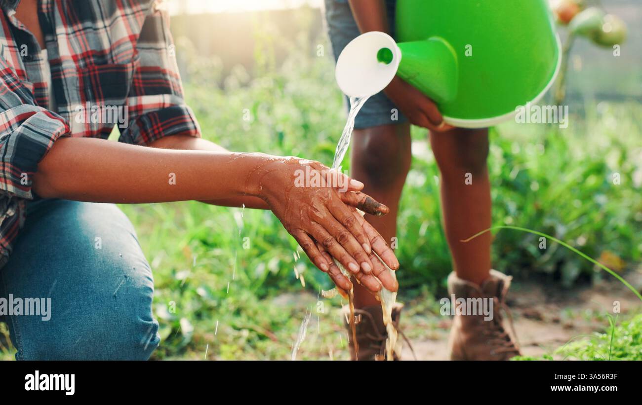 Environment, washing hands and watering can with people on farm for ...