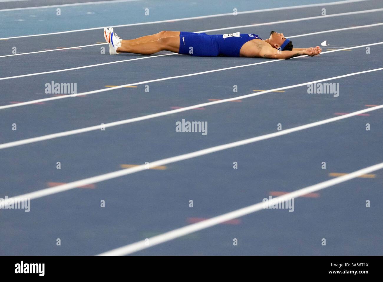 Eloy Benitez, of Puerto Rico, lies on the track after crashing during ...