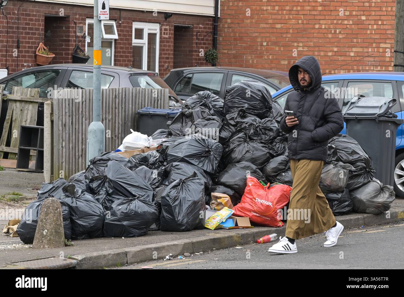 Calton Road, Birmingham 21st March 2025: A man walks past a large pile ...