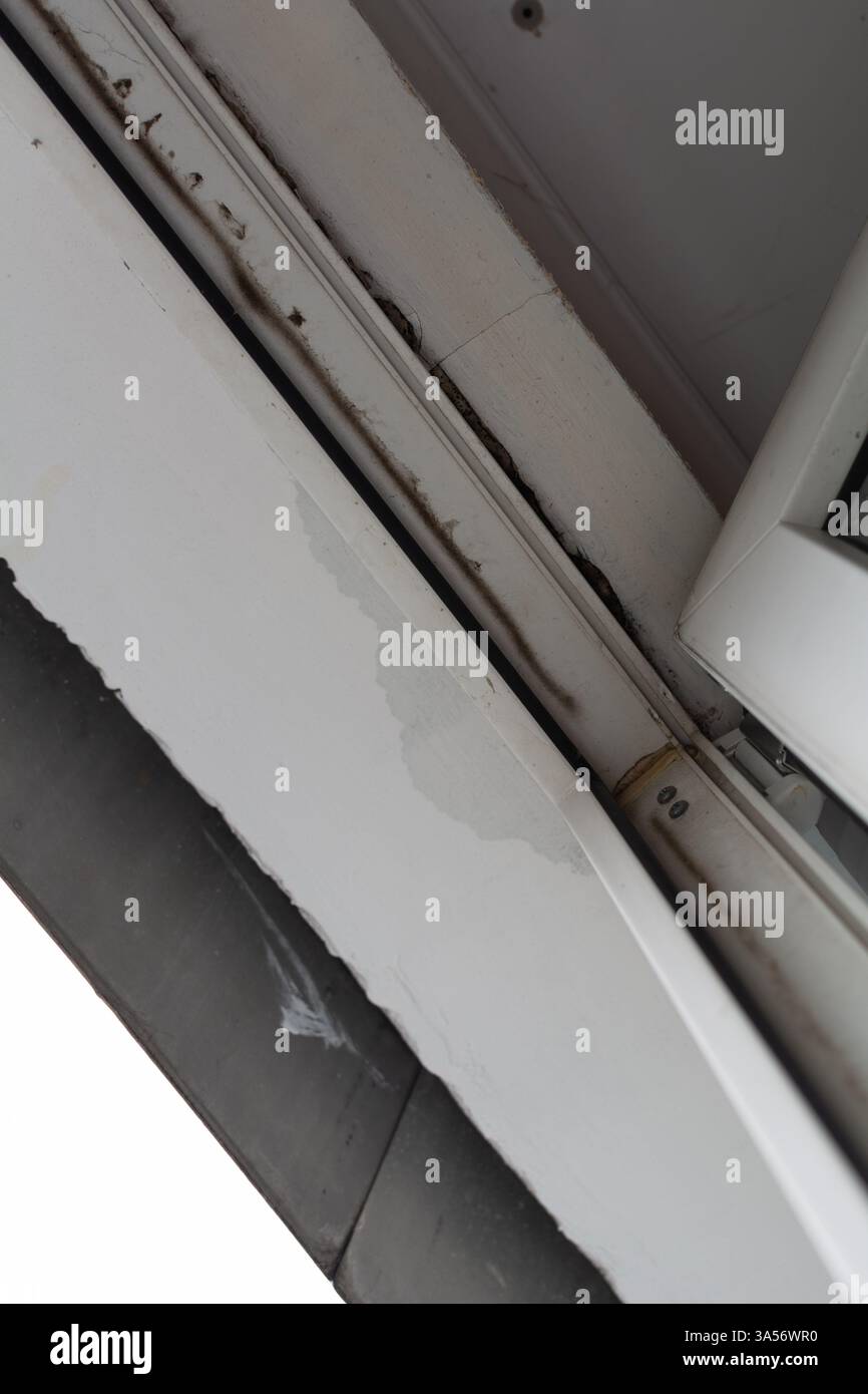 Rain drips between the window frame and the ceiling. Roof damage due to ...