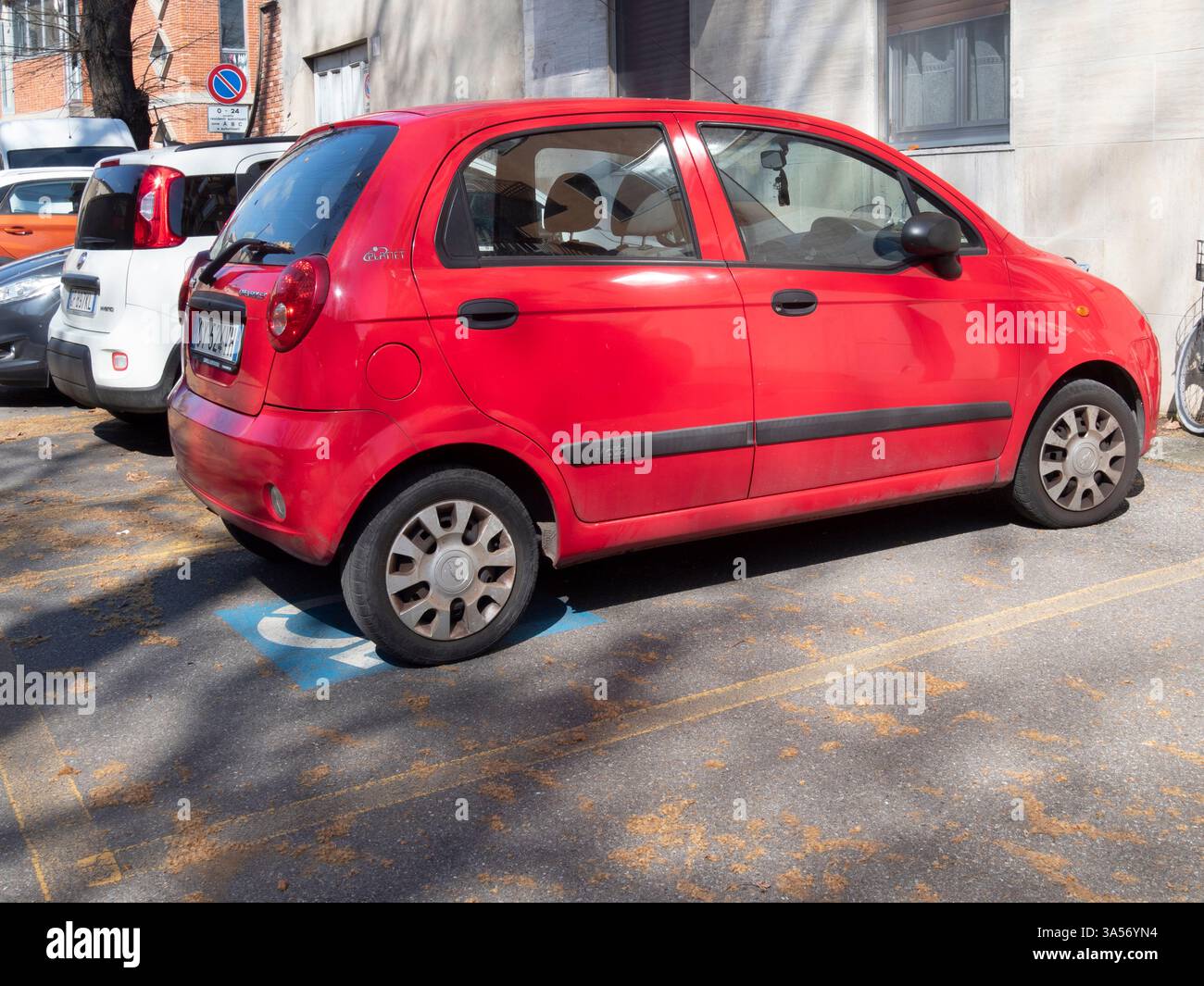Cremona, Italy March 15th 2025 Red Chevrolet Matiz parked in a disabled ...