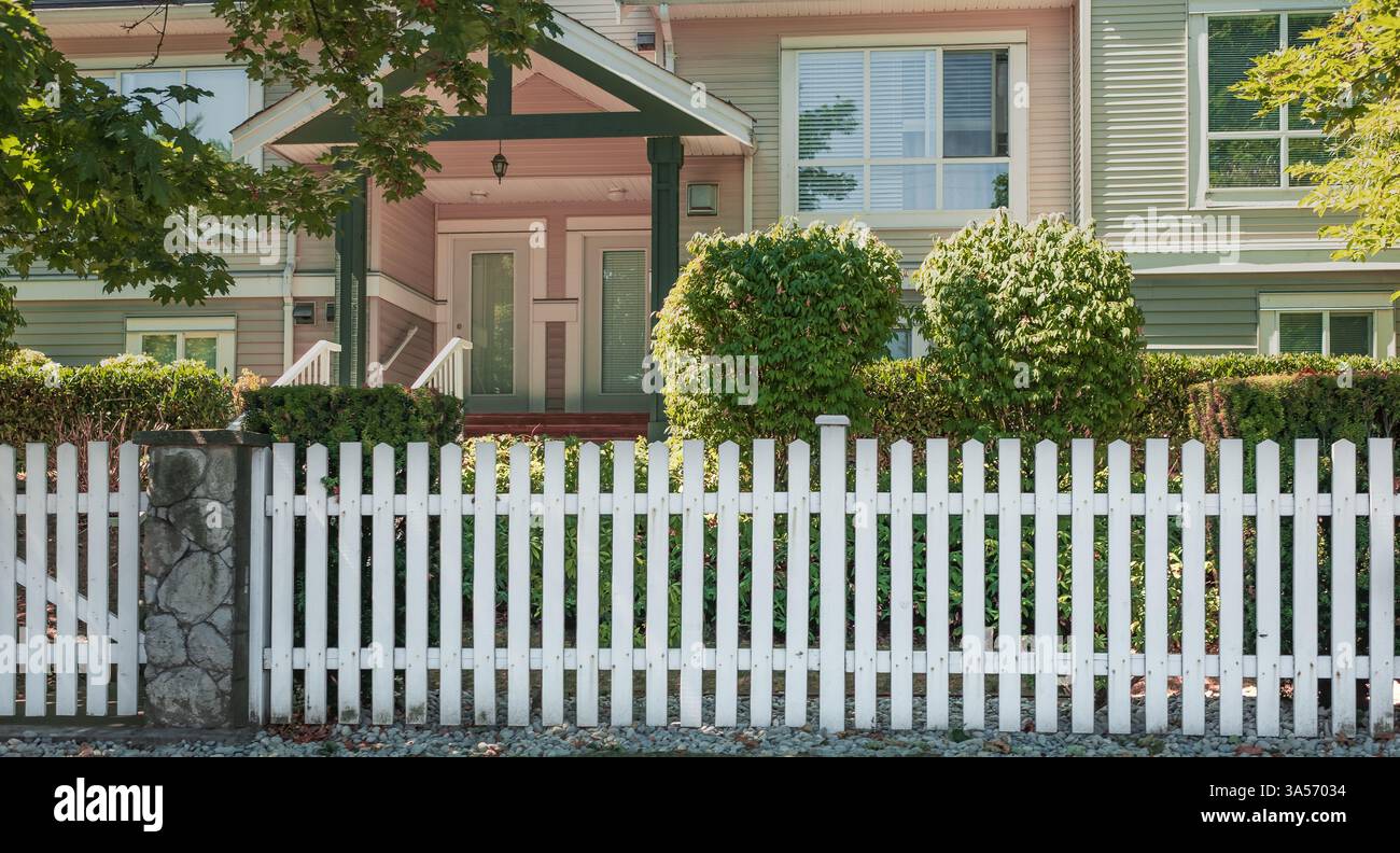 charming small town America cottage with picket fence with trees and ...