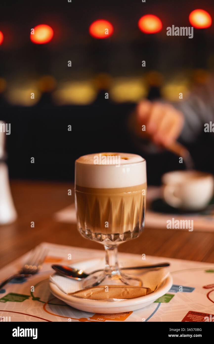 A glass of latte in a cozy cafe Stock Photo - Alamy