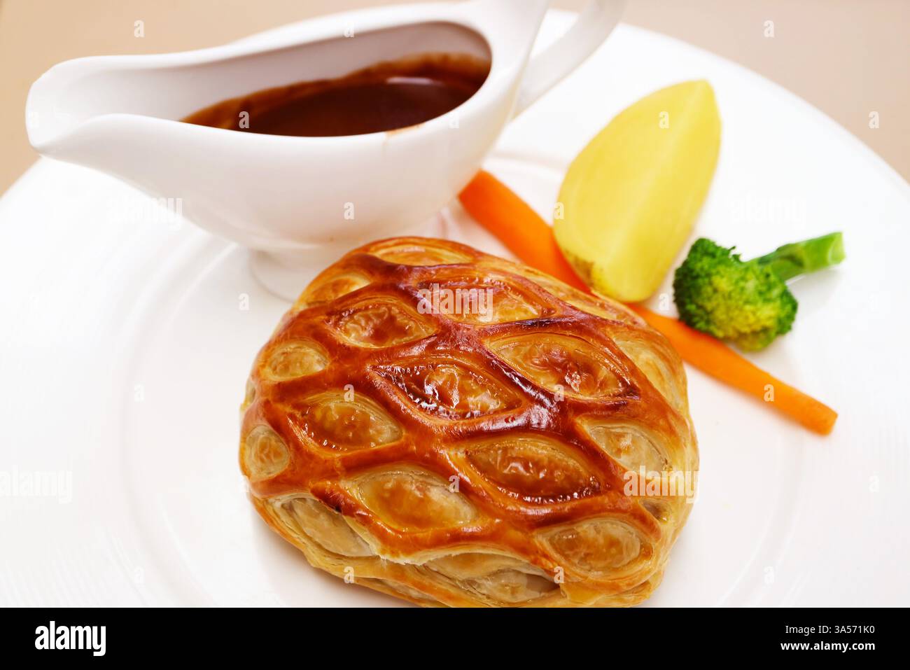 Plate of Golden Brown Beef Wellington Served with Red Wine Sauce Stock ...