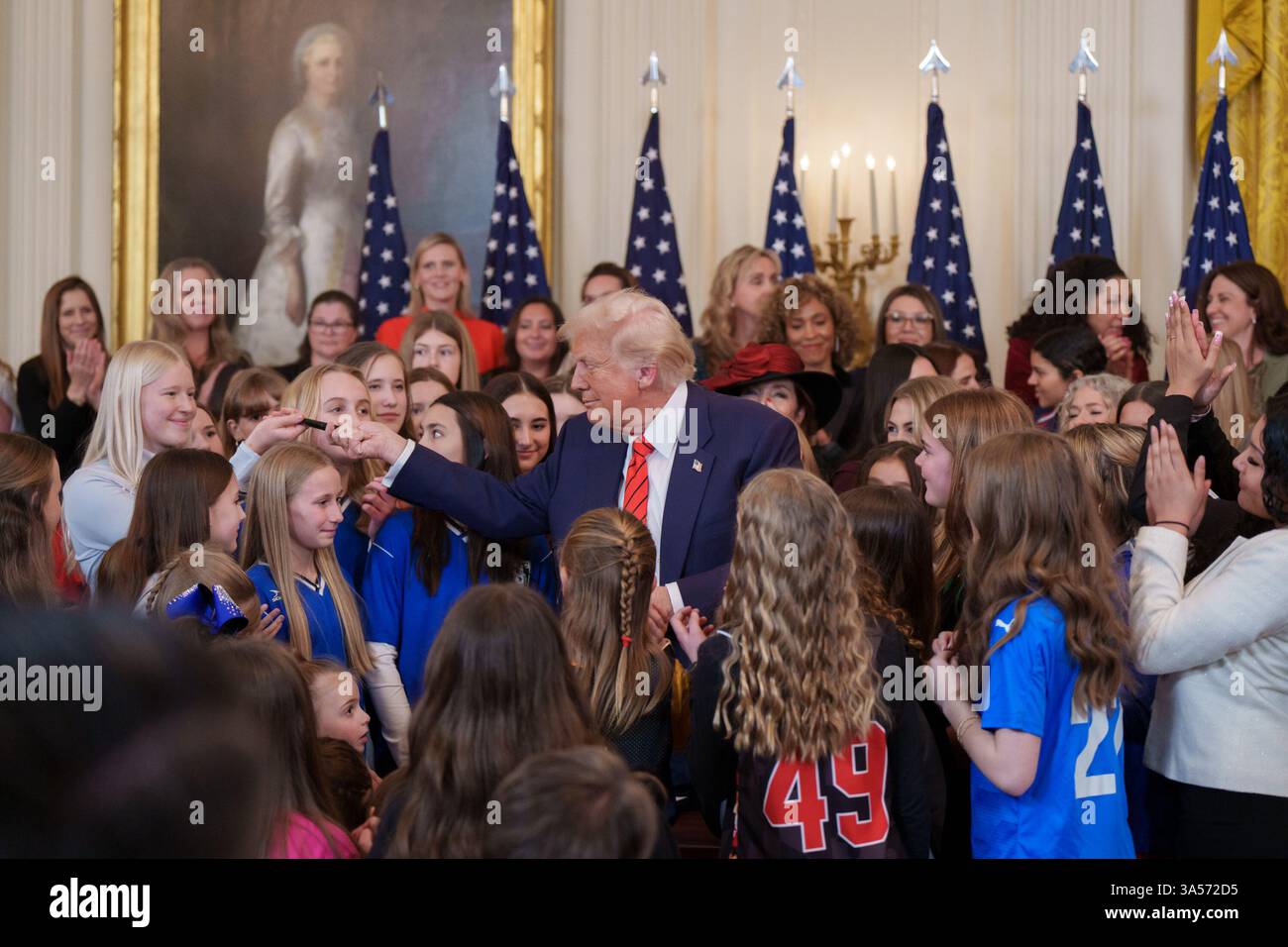 President Donald Trump - surrounded by women and girls - delivers ...