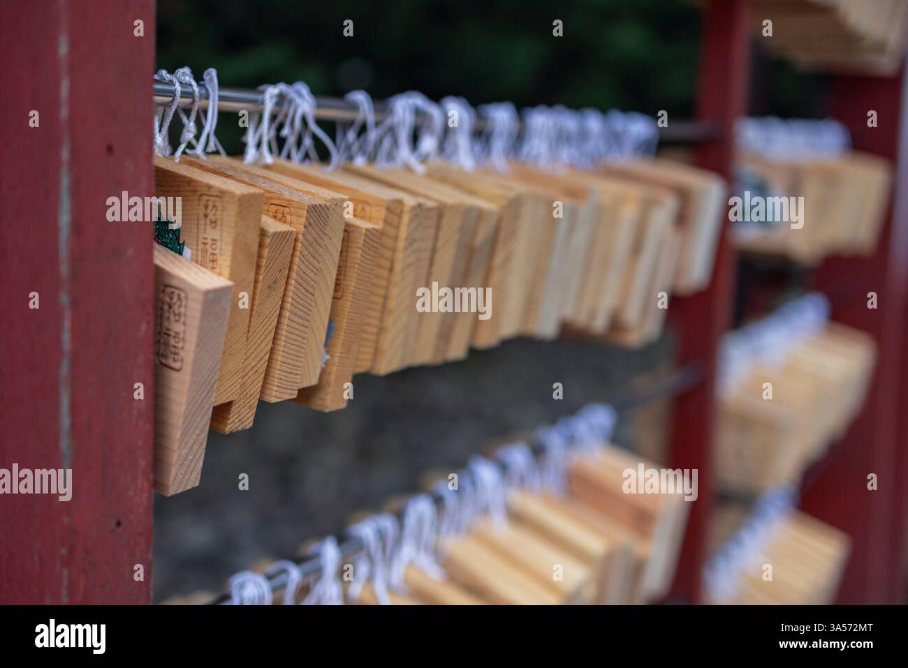 Close-up of traditional wooden ema boards hanging at a Shinto shrine in ...