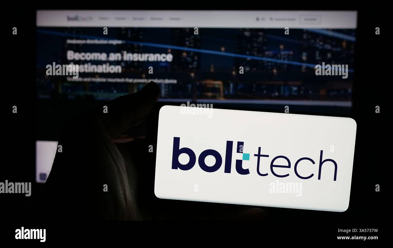 Stuttgart, Germany - 11-17-2024: Person holding mobile phone with logo of Singaporean insurtech ...